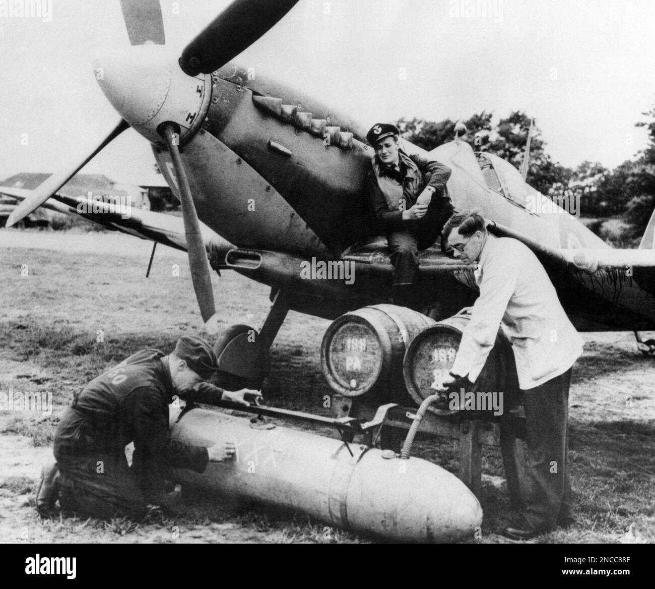 A long range fuel tank of a spitfire, converted to hold beer, is being ...