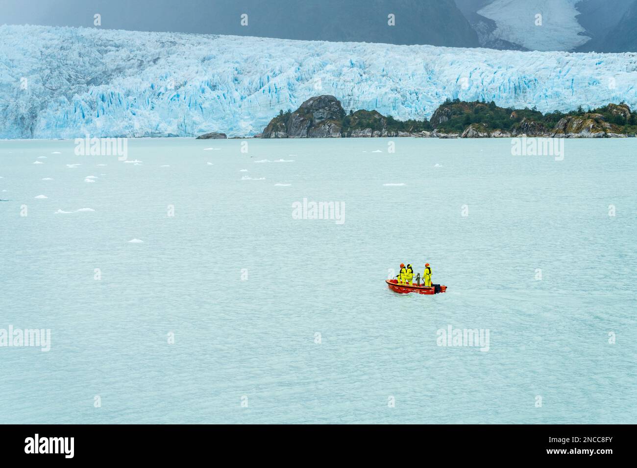 Crew in small power boat collecting iceberg by Amalia Glacier in ...