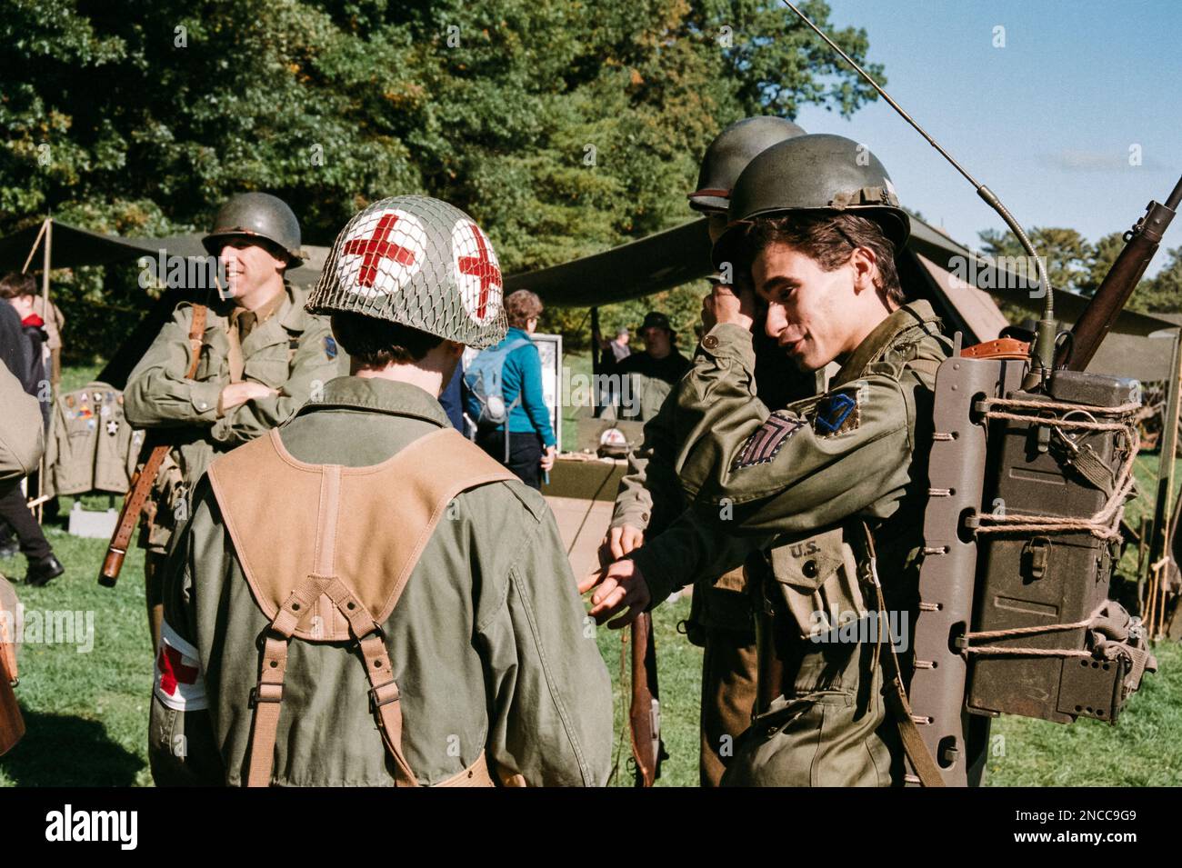 Red Cross medics and a mobile radio operator in a tent camp during a ...