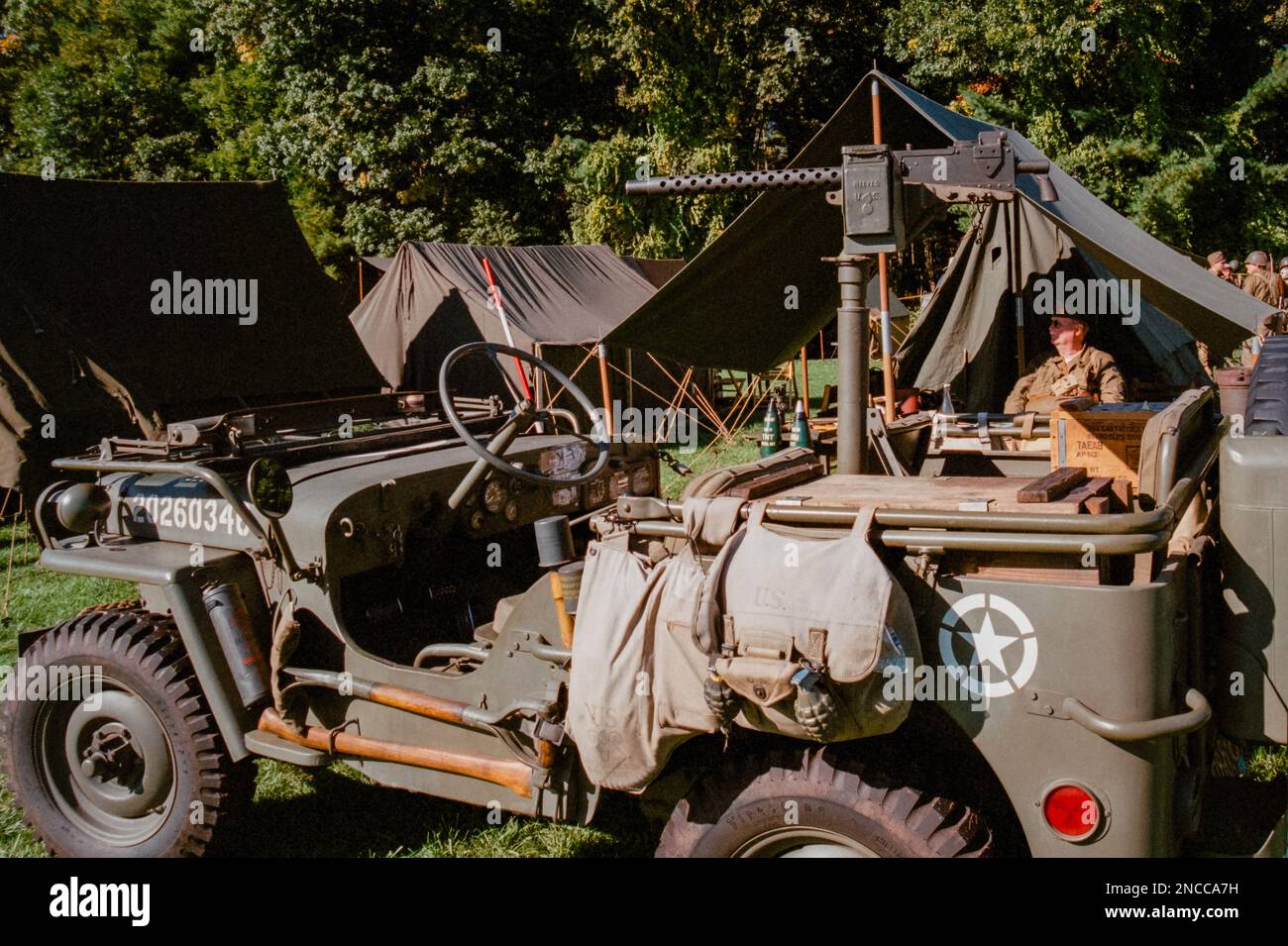 A classic Army Jeep with a machinegun mounted to the top and ammunition ...