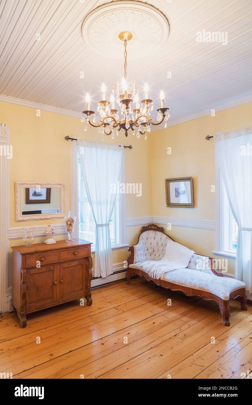 Sculpted wood and upholstered recamier with white throw and small ...