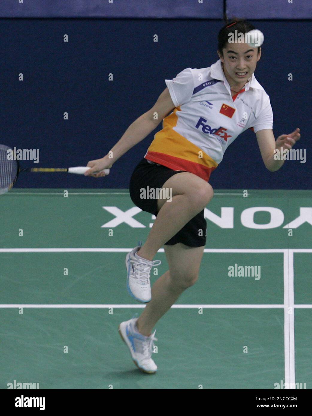 China's Wang Shixian returns a shot to her compatriot Wang Yihan during ...