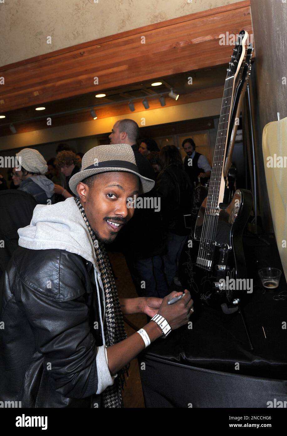 Musician Frank Bell signs a Fender guitar at the Fender Music Lodge ...