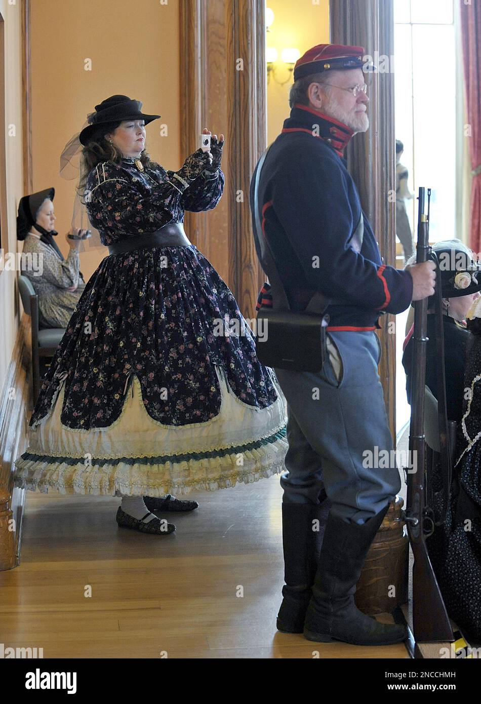 In this Jan. 15, 2011 photo, the old and the new meet as re-enactors ...