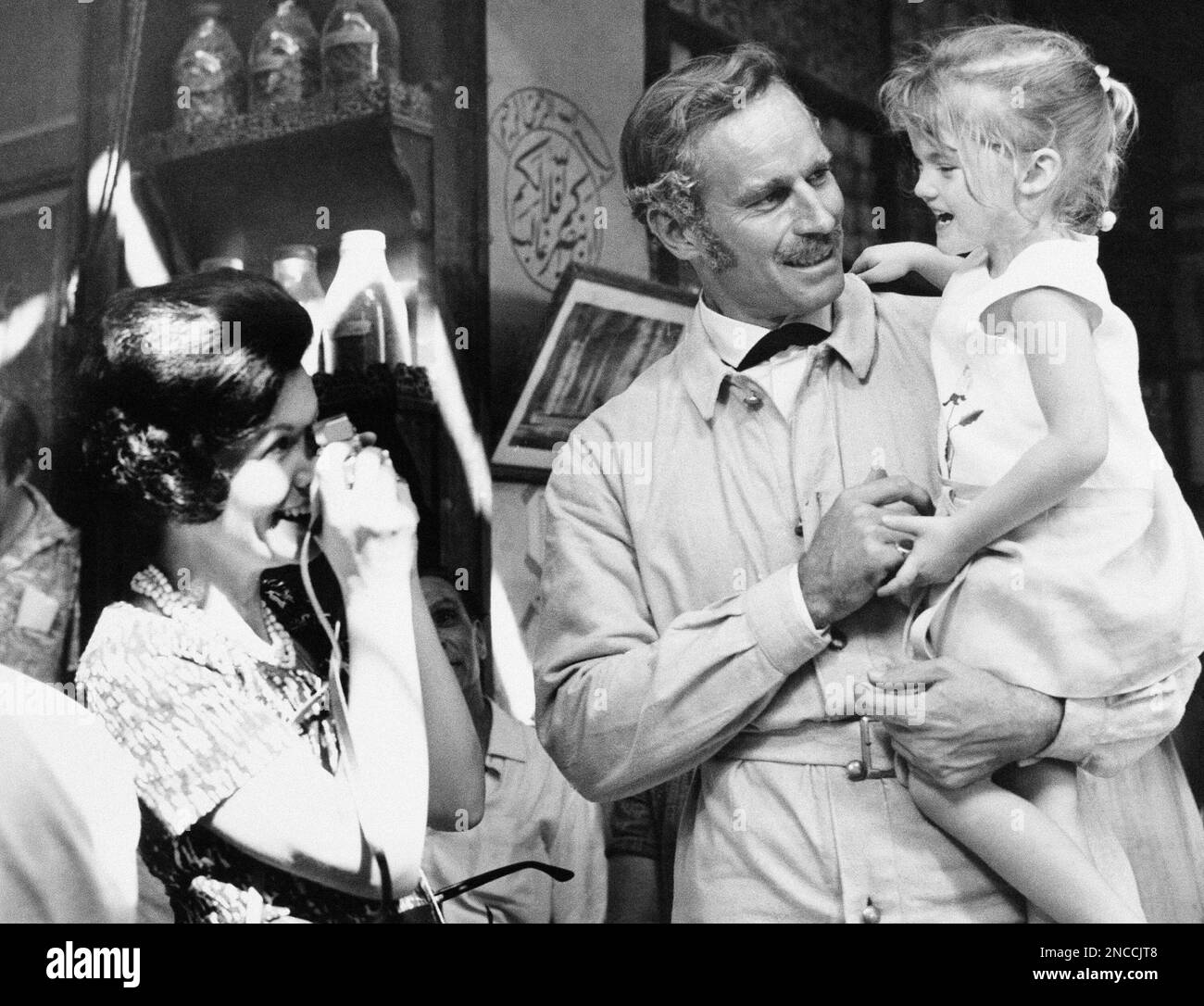 Mugging like an actor’s daughter, Holly Ann Heston, in the arms of her ...