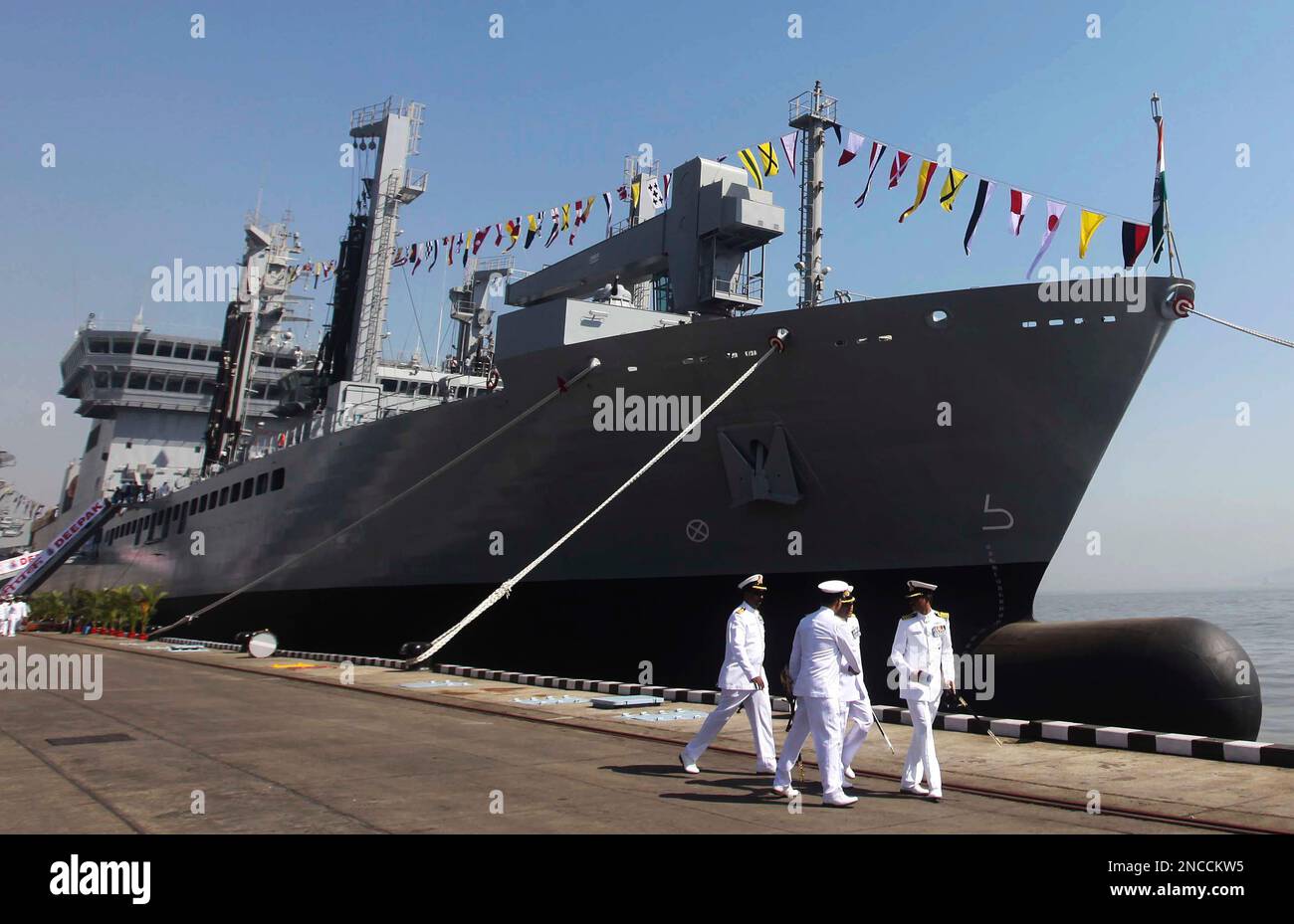 Indian naval officers walk past the Italian-built fleet tanker "INS ...