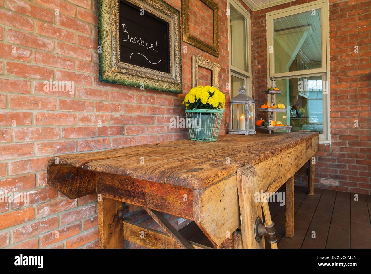Old used and worn rustic wooden workshop bench in veranda at the back ...