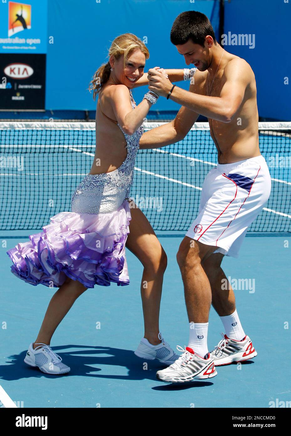 Serbia's Novak Djokovic, right, is given a ballroom dancing lesson on a ...