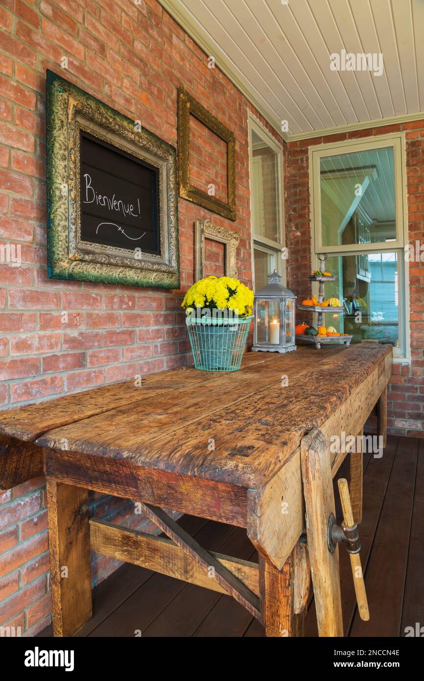 Old used and worn rustic wooden workshop bench in veranda at the back ...