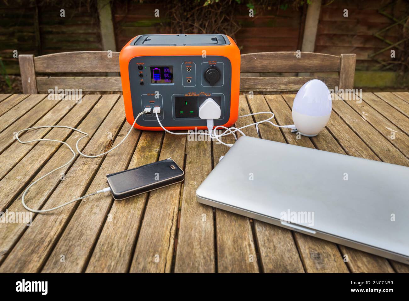 Portable power station solar electricity generator on table with laptop ...