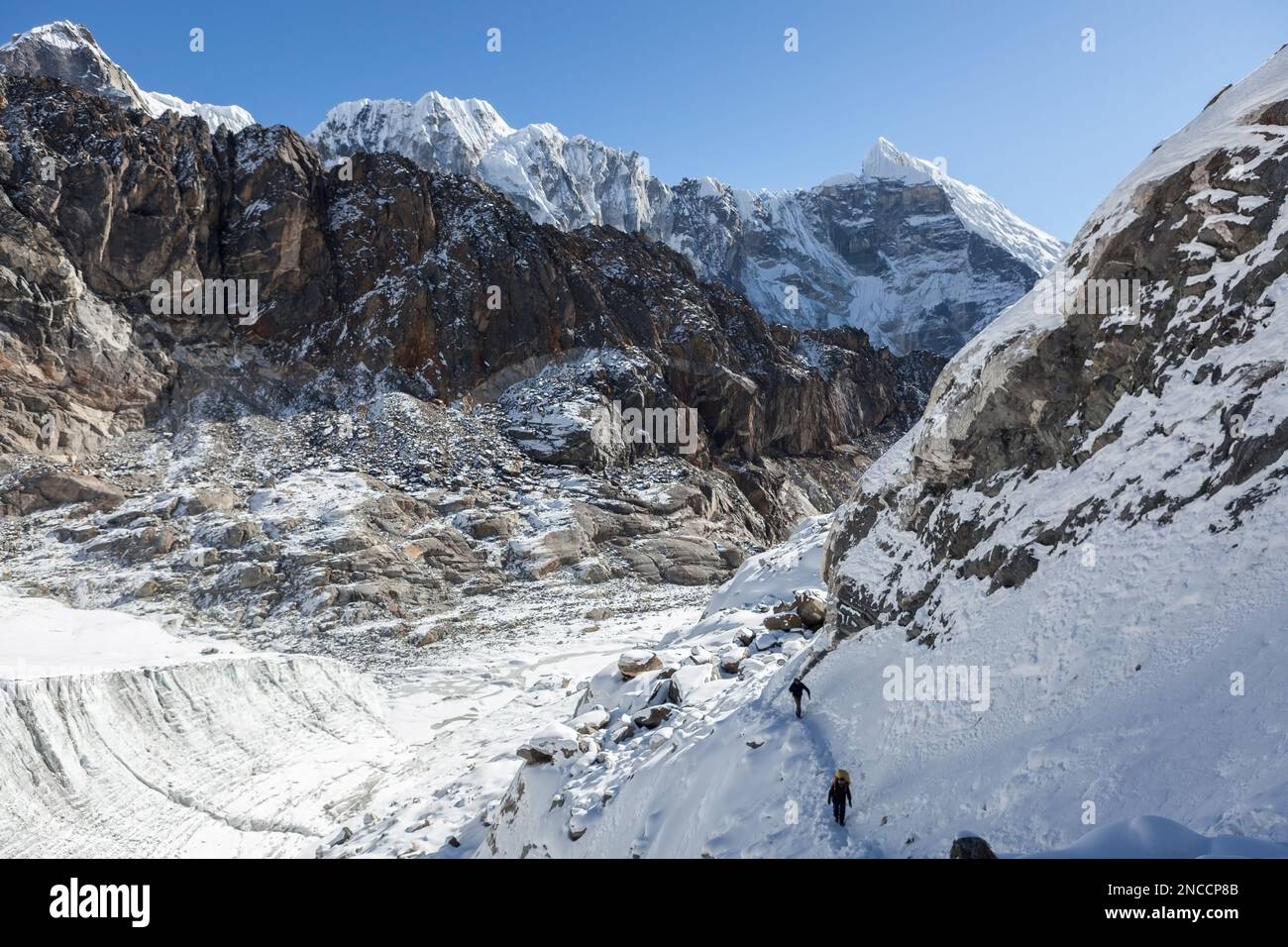 Extreme trekking concept. Group of travellers walking along the ...