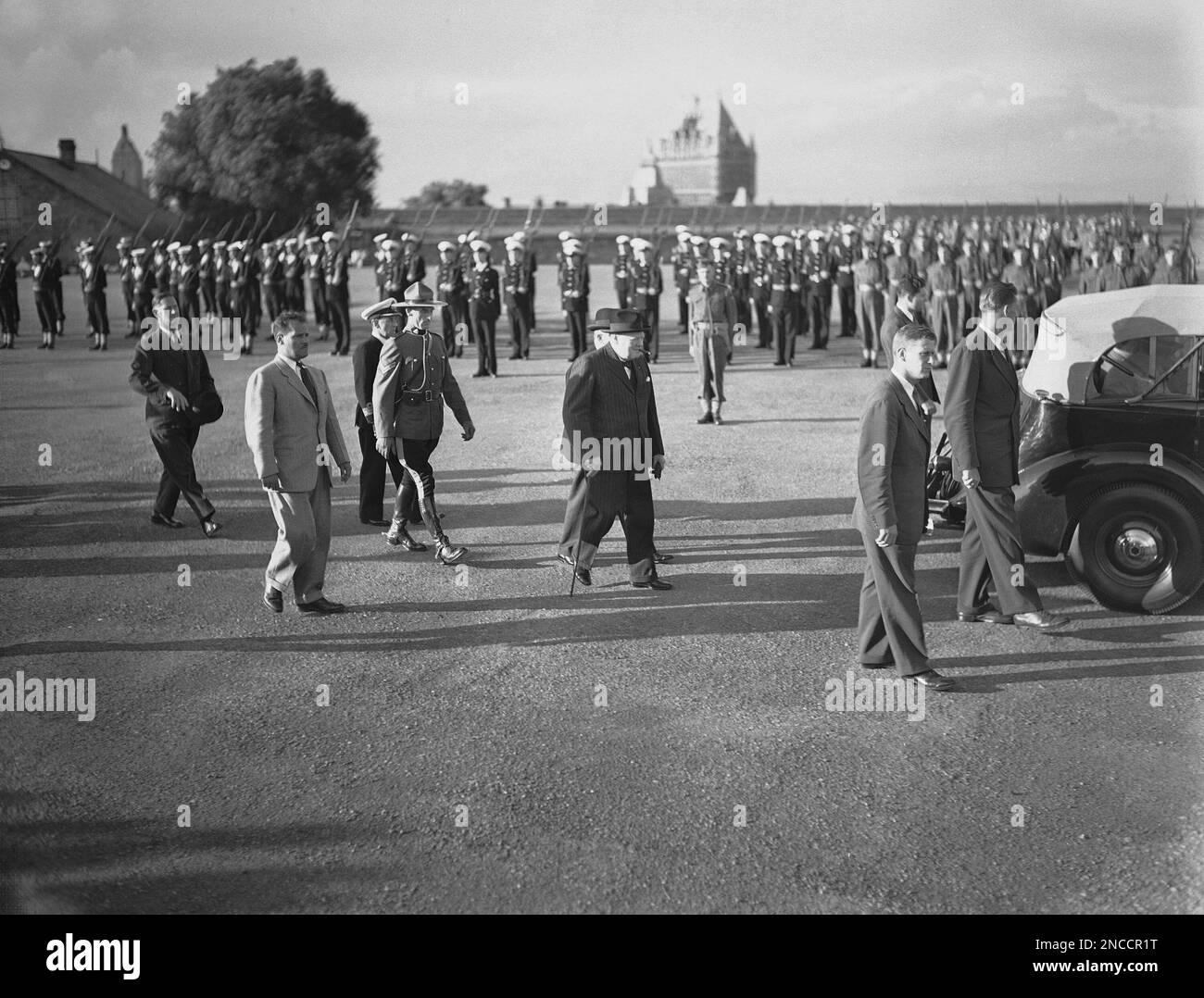 Prime Minister Winston Churchill, extreme right, as he walked across ...