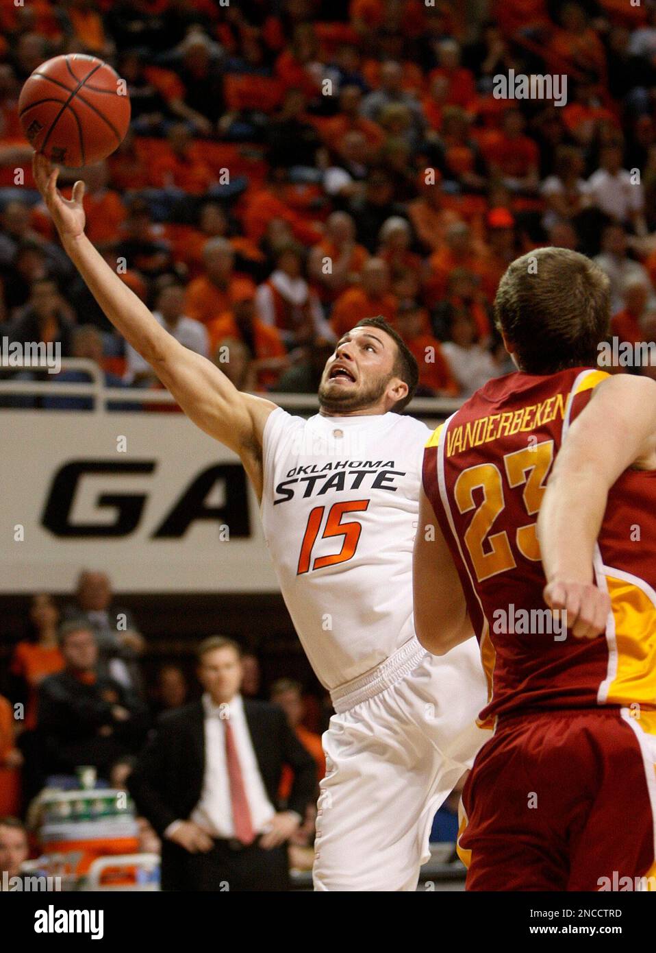 Oklahoma State guard Nick Sidorakis, left, shoots in front of Iowa ...
