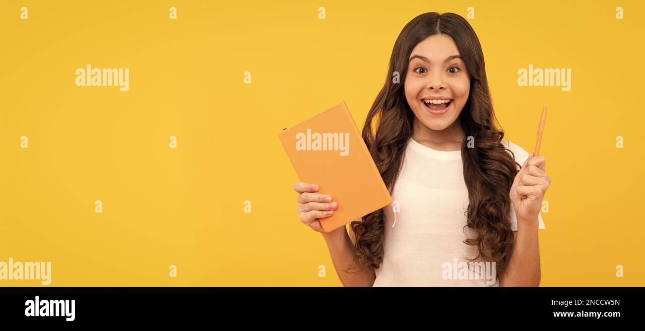 surprised school kid ready to study with bookand pen. Portrait of ...