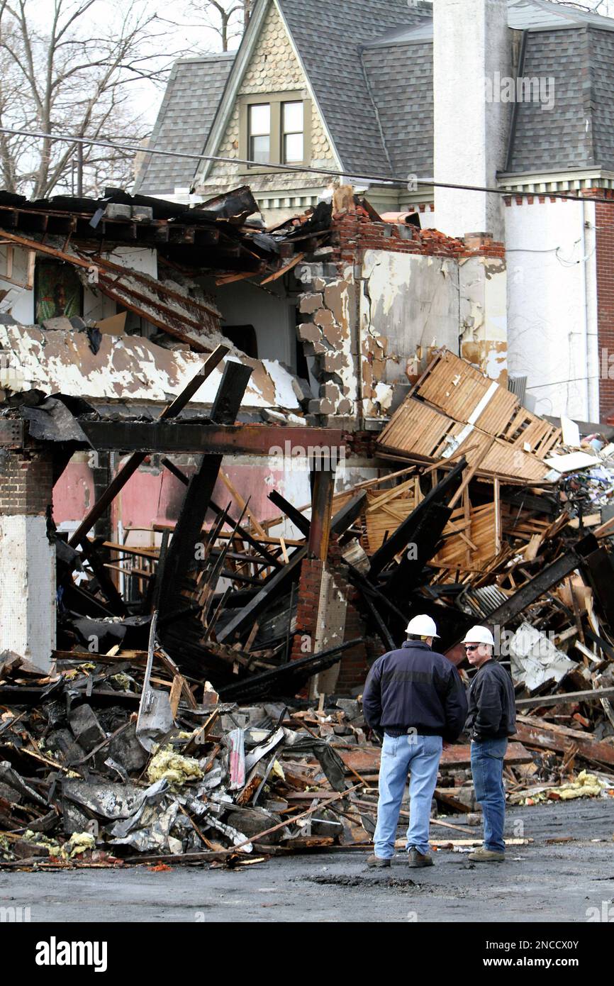 Officials oversee the removal of debris from the site of a gas main ...