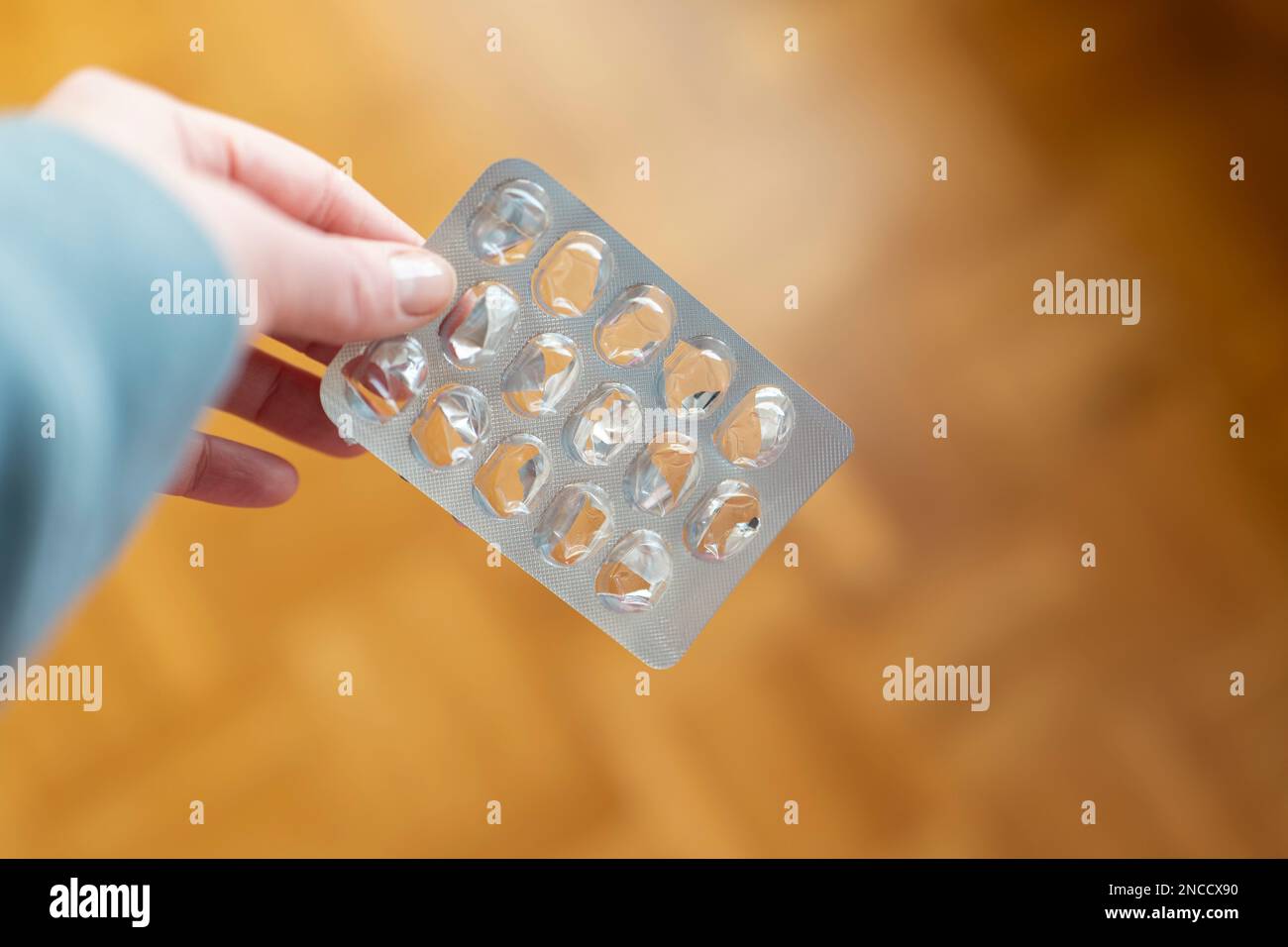Empty pill box. Empty packaging of pills in a hand on brown floor ...