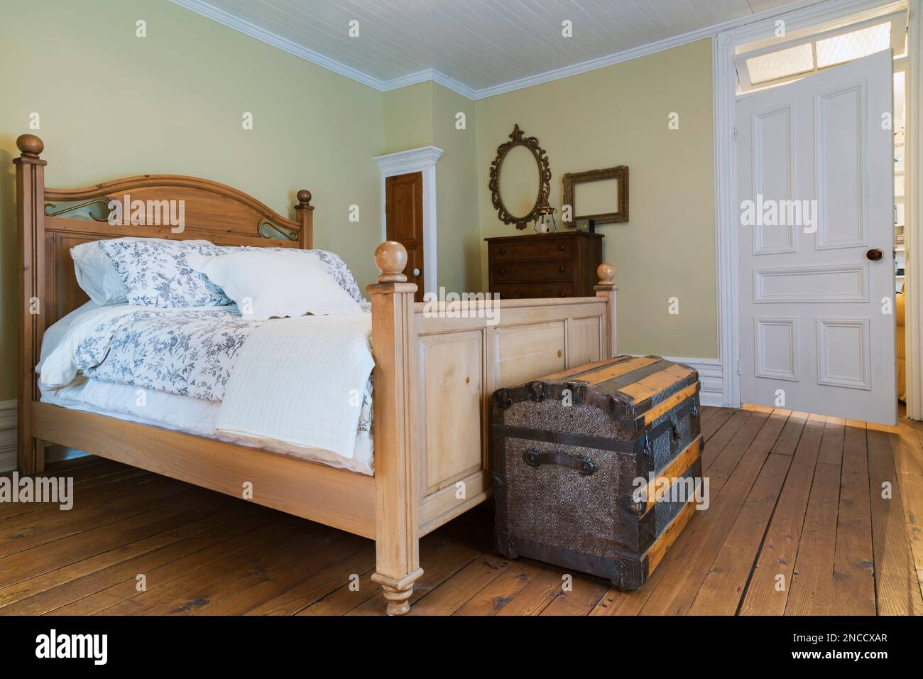 Queen size bed with wooden headboard and footboard, antique travel ...