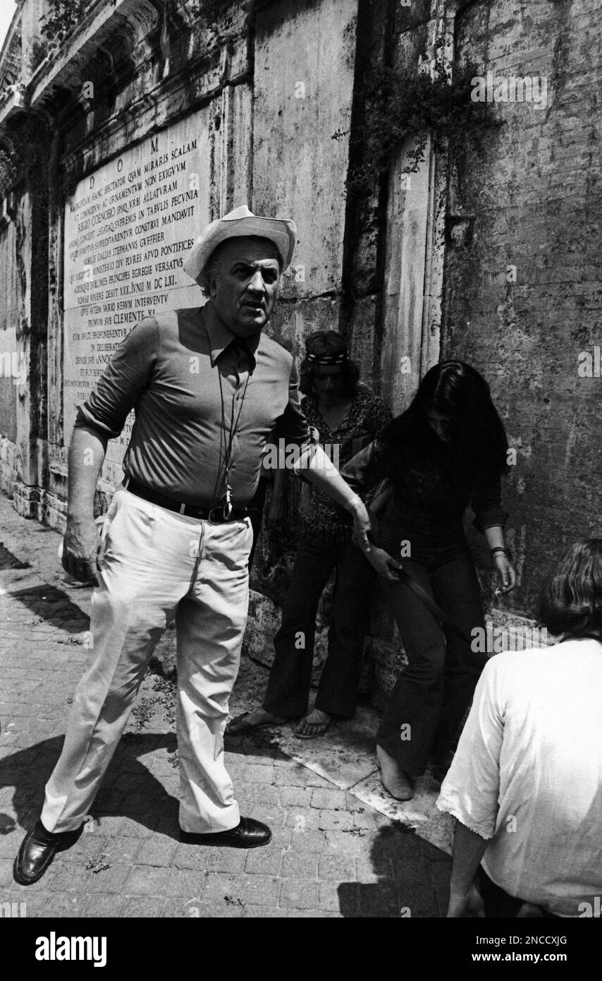 Italian director Federico Fellini is surrounded by actors, who portray ...