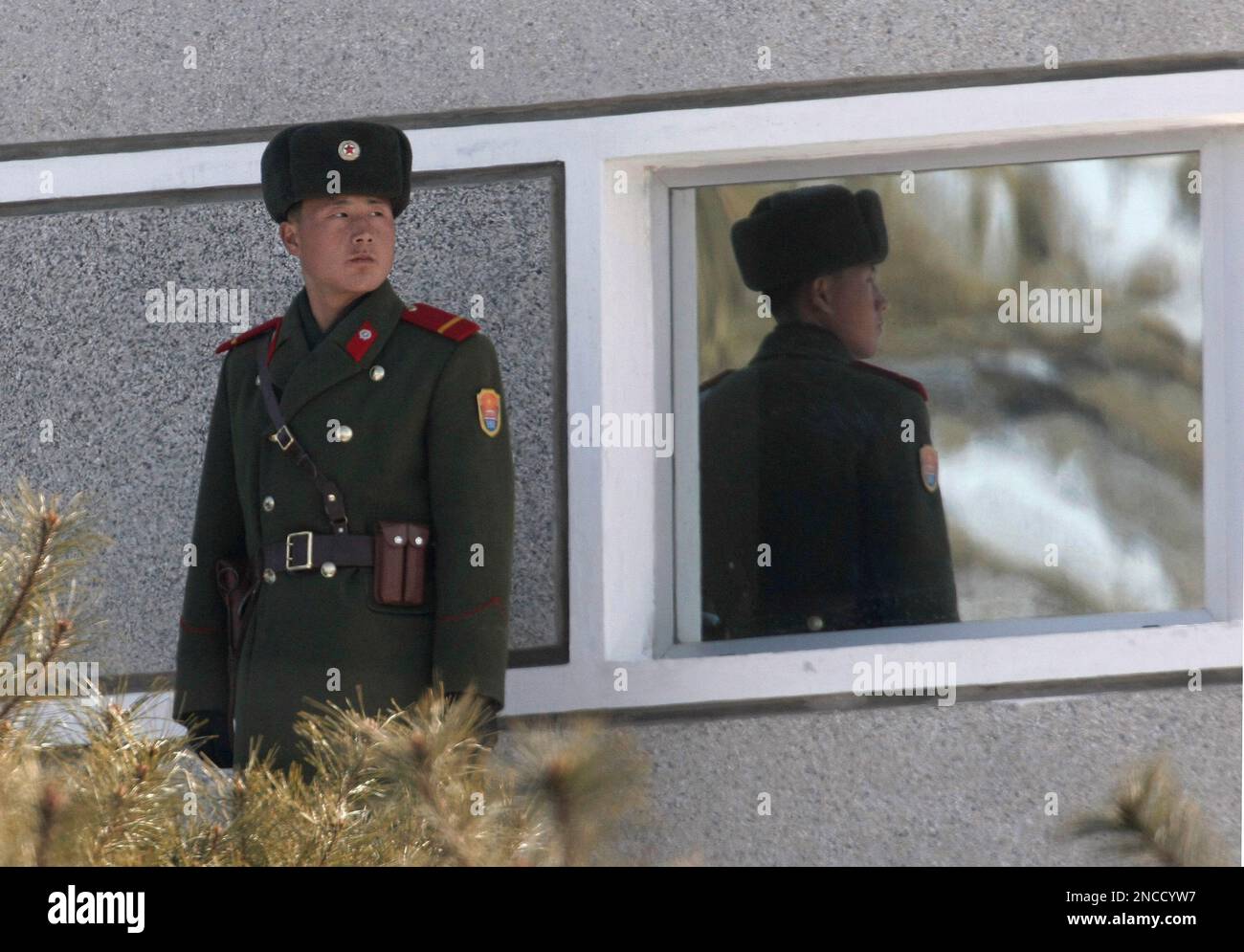 A North Korean soldier watches the southern side at the border village ...