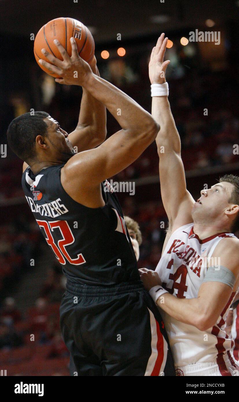 Texas Tech forward Mike Singletary, left, shoots over Oklahoma guard ...
