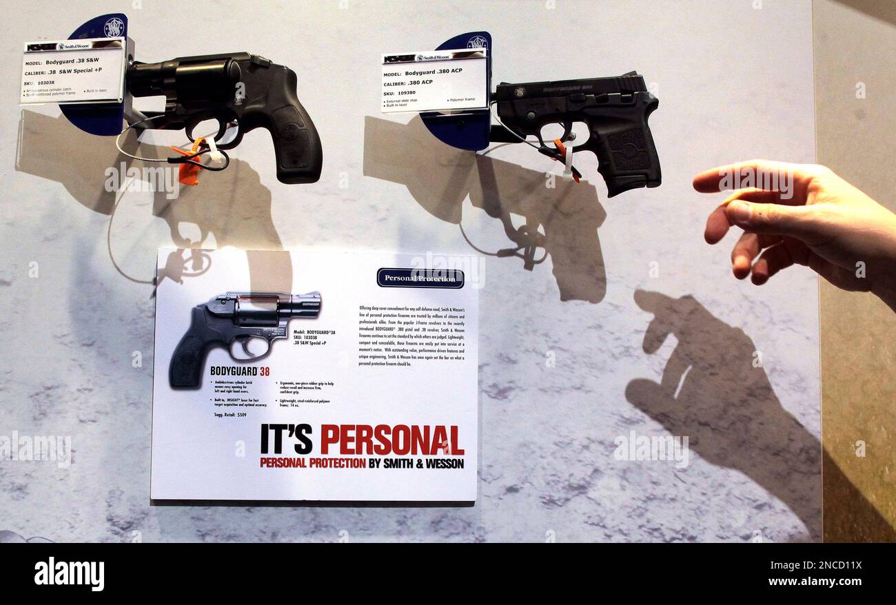 Smith & Wesson hand guns hang on display at the Shooting, Hunting and ...