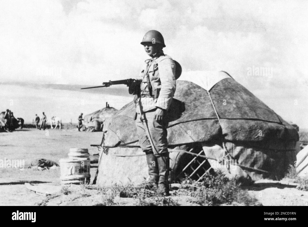 A Japanese sentry stands near a yuerta at a supply base back of the ...