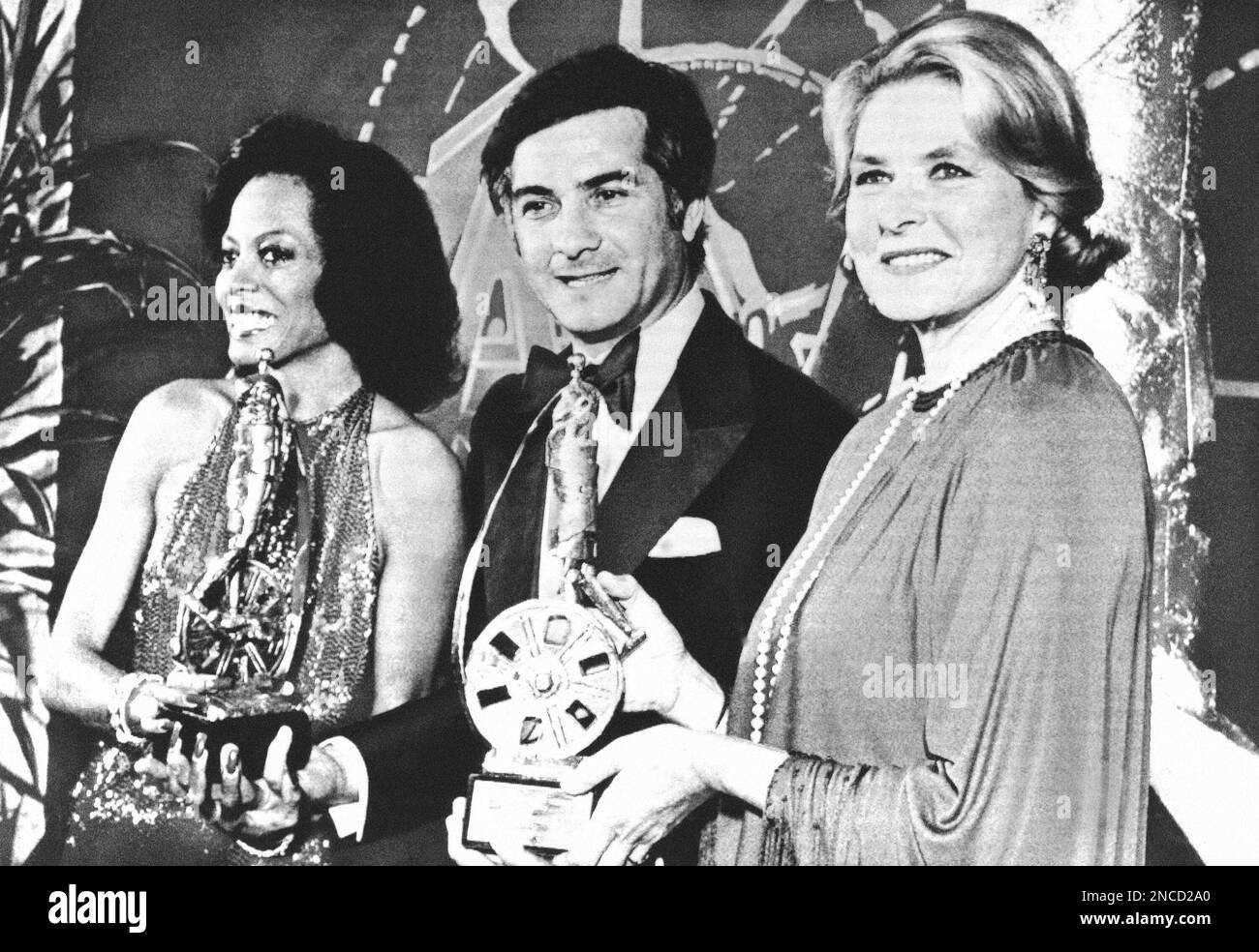 Swedish actress Ingrid Bergman, right, holds the Caesar Award presented ...