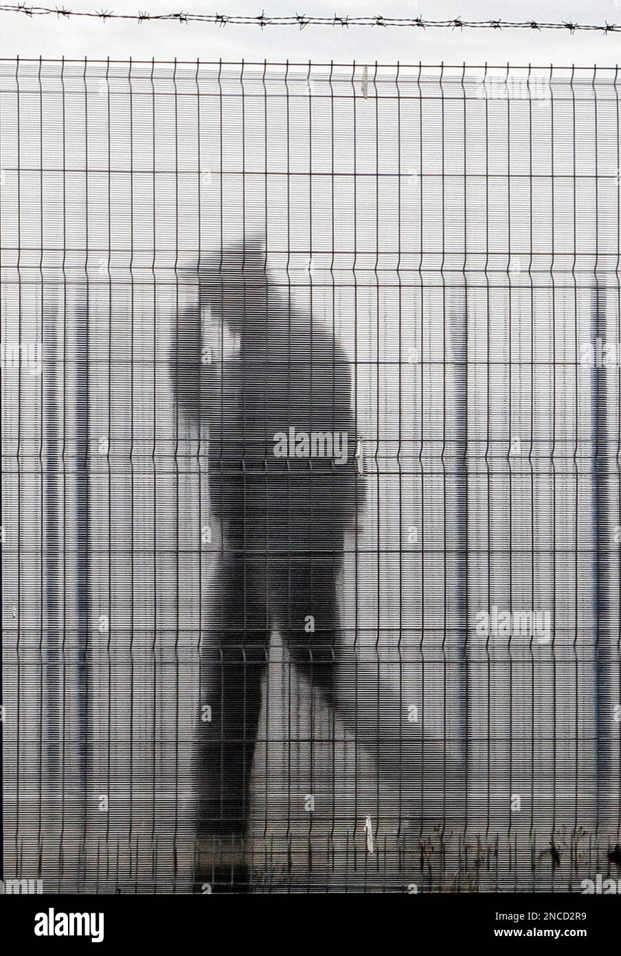A Romanian border policeman patrols a railway border crossing point ...