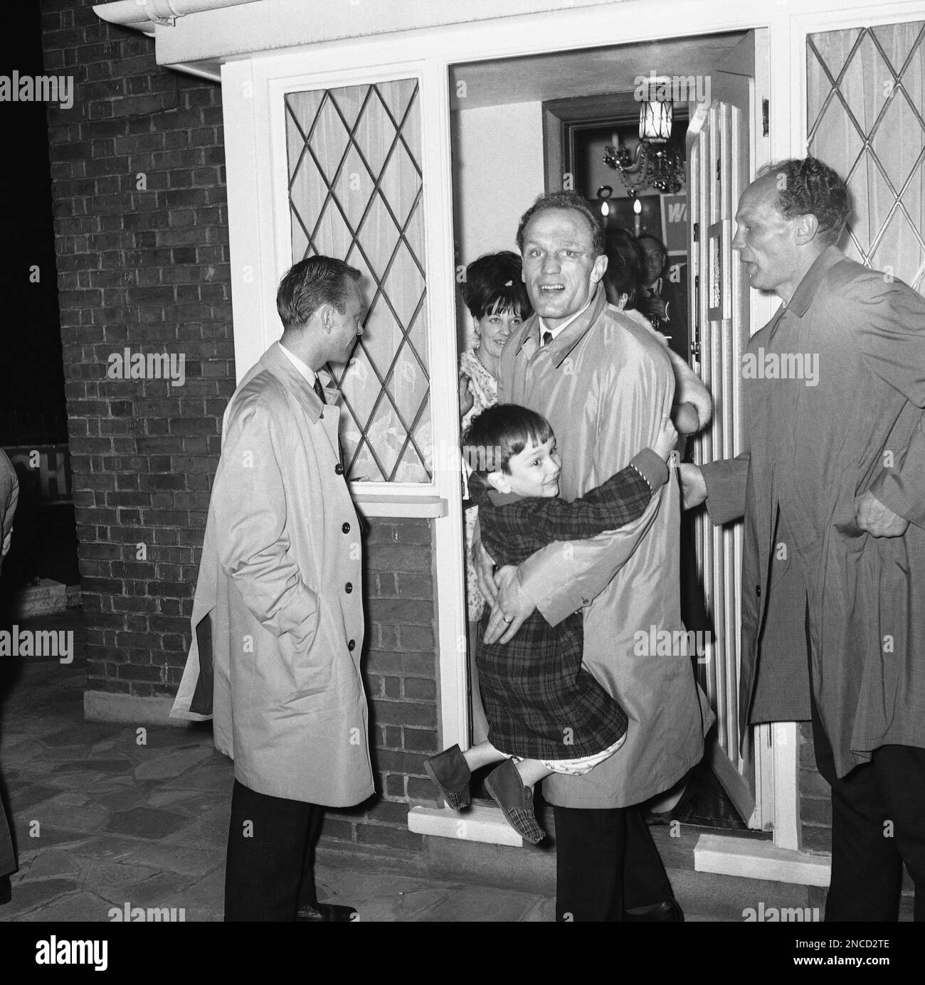 British Heavyweight Champion Henry Cooper receives a hug and warm ...