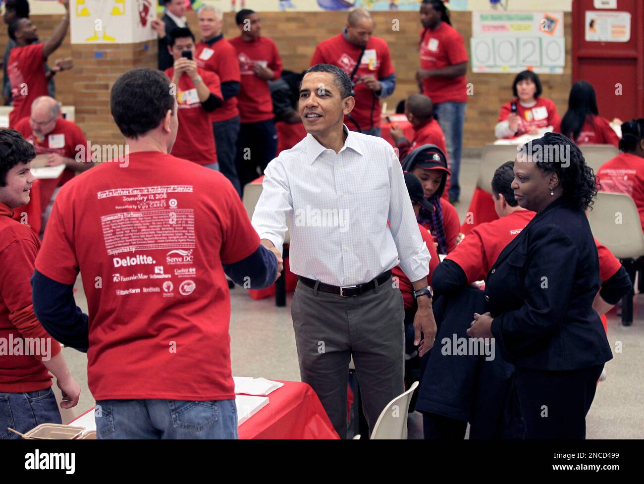 President Barack Obama greets volunteers as he and first lady Michelle ...