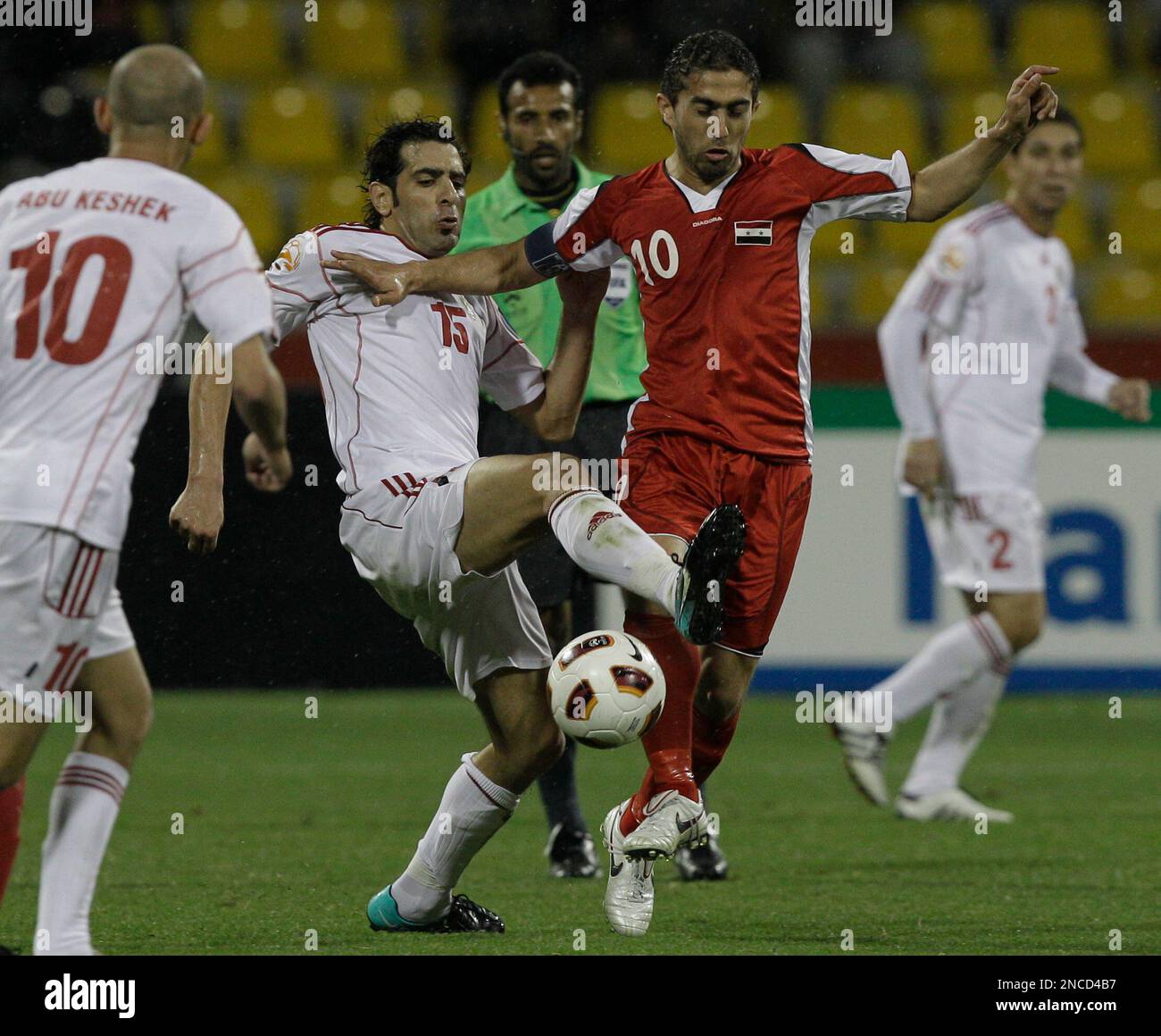 Syria's player Firas Al Khatib, second right fights for the ball with ...