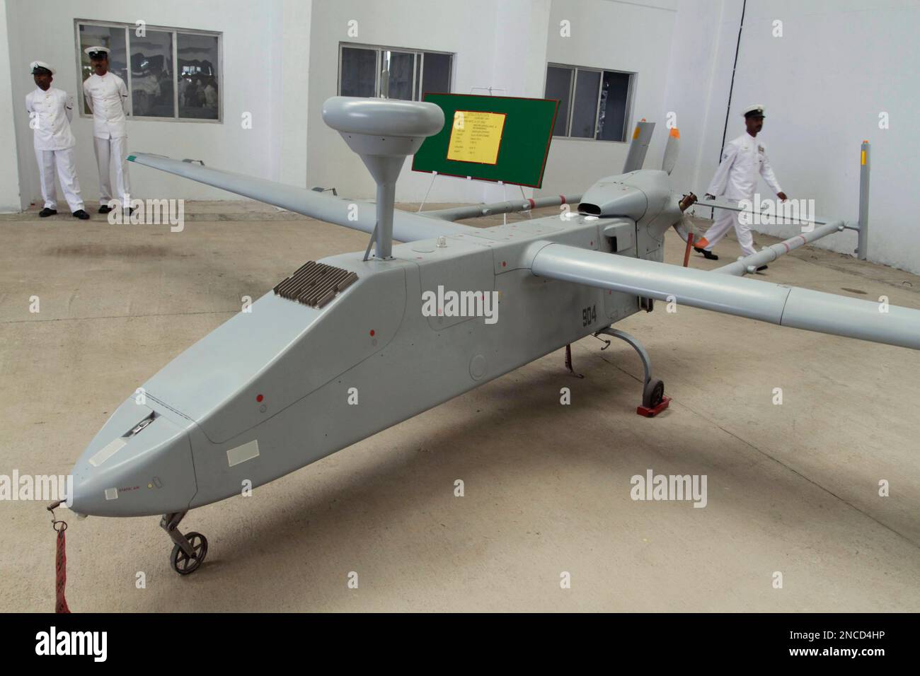 Indian Navy personnel stand near an Unmanned Aerial vehicle (UAV) Heron ...