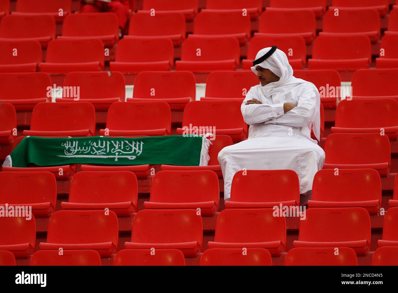 A Saudi Arabian fan sits in the stadium before the AFC Asian Cup group ...