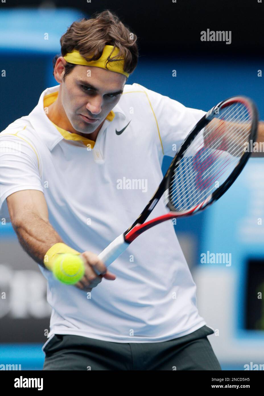 Switzerland's Roger Federer makes a backhand return to Slovakia's Lukas ...