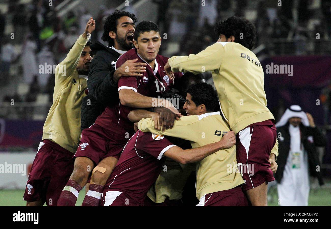 Qatar players celebrate after scoring their third goal against Kuwait ...