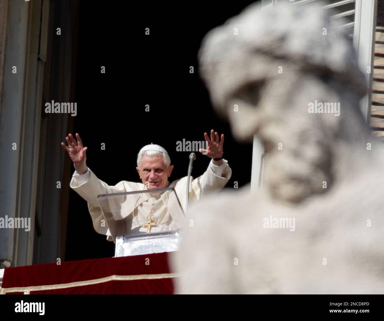 Pope Benedict XVI waves at faithful at the end of the Angelus prayer ...
