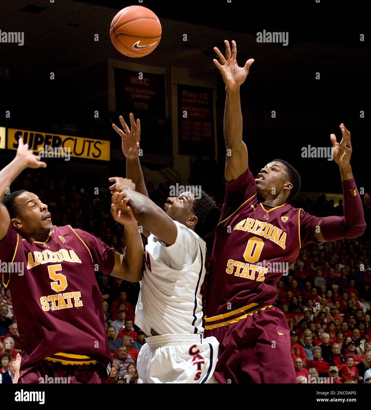 Arizona's Solomon Hill, center, rebounds against Arizona States' Kyle ...