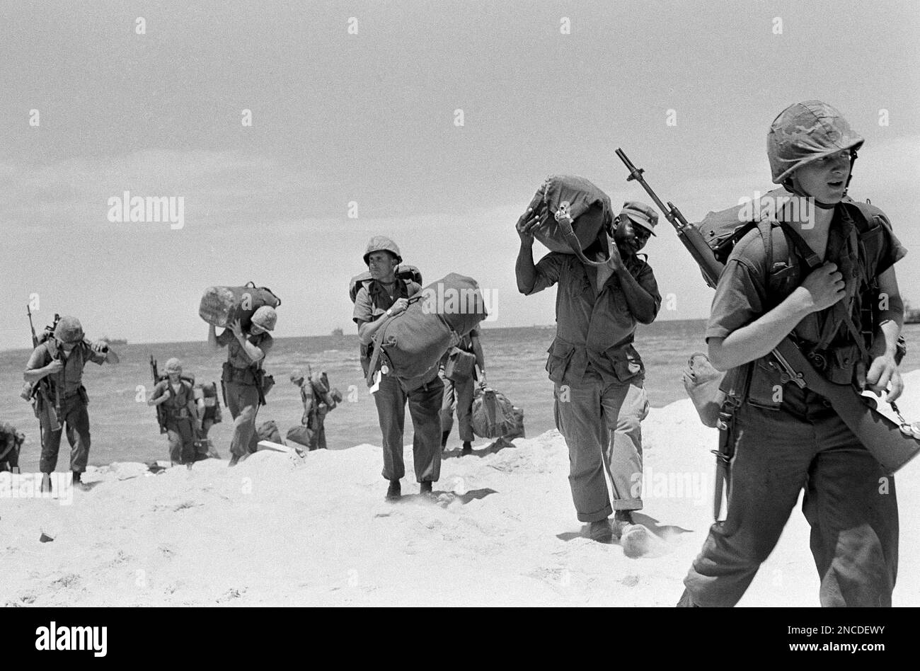 Elements of the U.S. Marines First Division trudge through sand at Chu ...