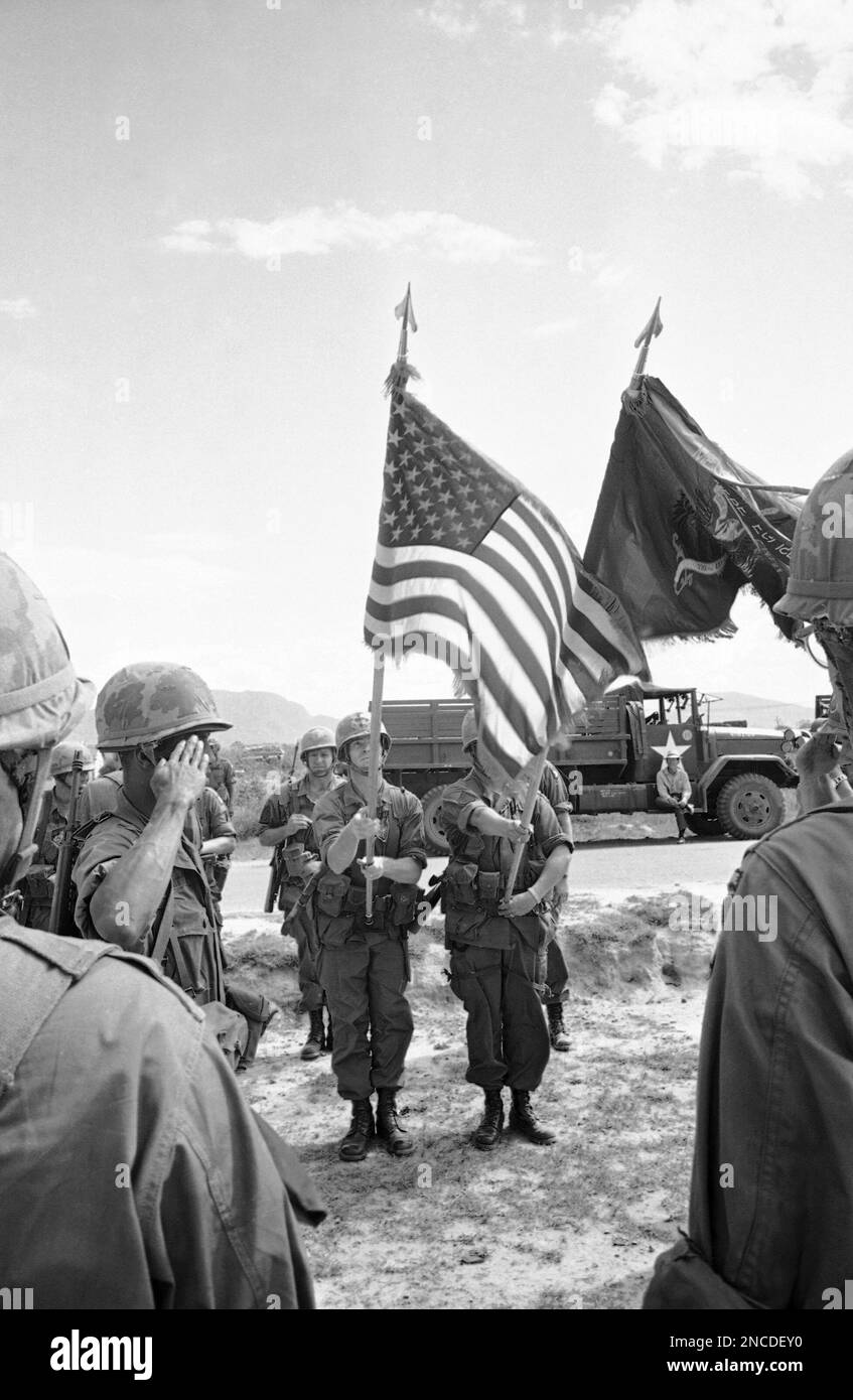 Troopers of the U.S. 101st Airborne Division stand at attention as flag ...