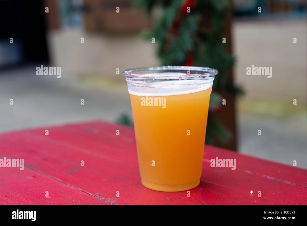 A top-down view of a clear glass of brewed ale of Belgian beer. The ...