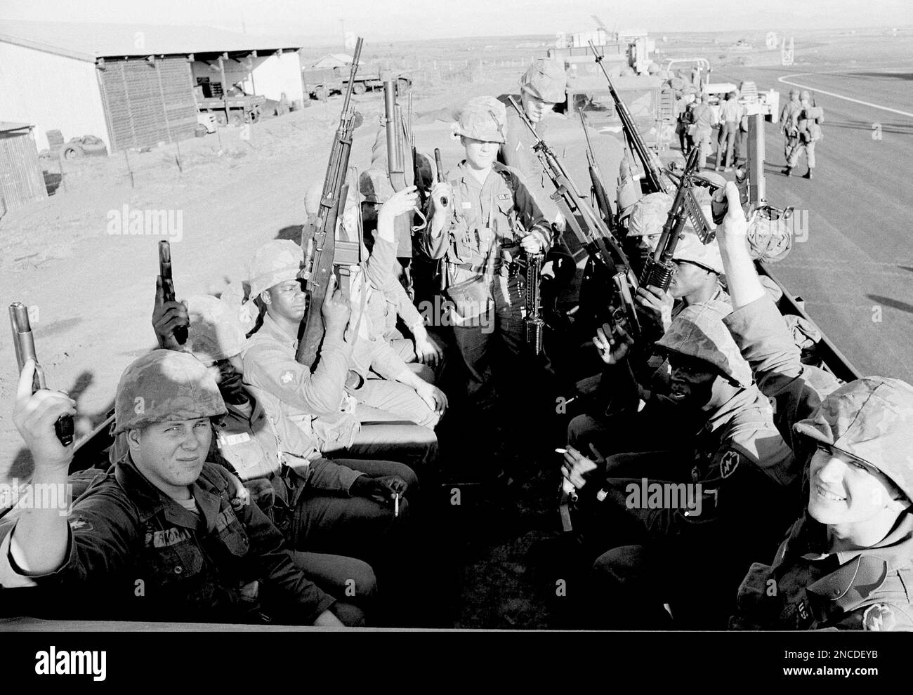 Soldiers of the U.S. Army's 25th Division 3rd Brigade wave weapons as ...