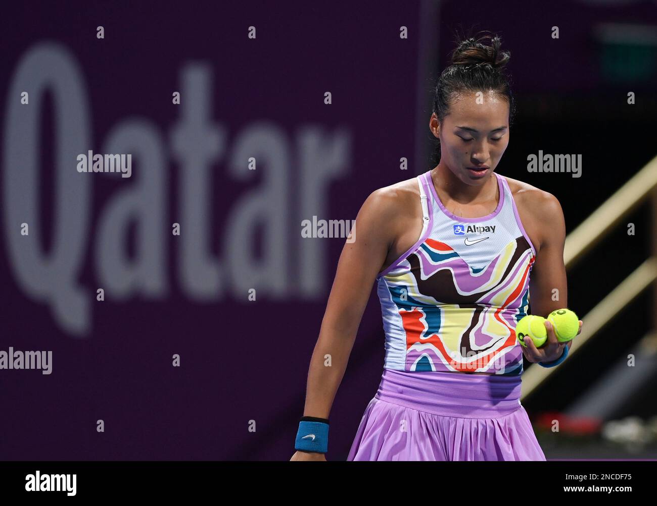 Doha, Qatar. 14th Feb, 2023. Zheng Qinwen of China prepares to serve ...