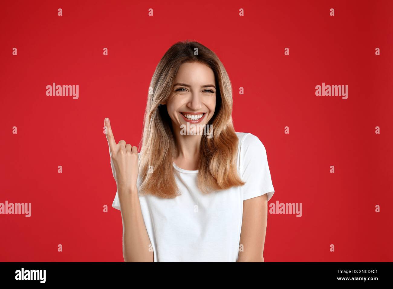 Woman showing number one with her hand on red background Stock Photo ...