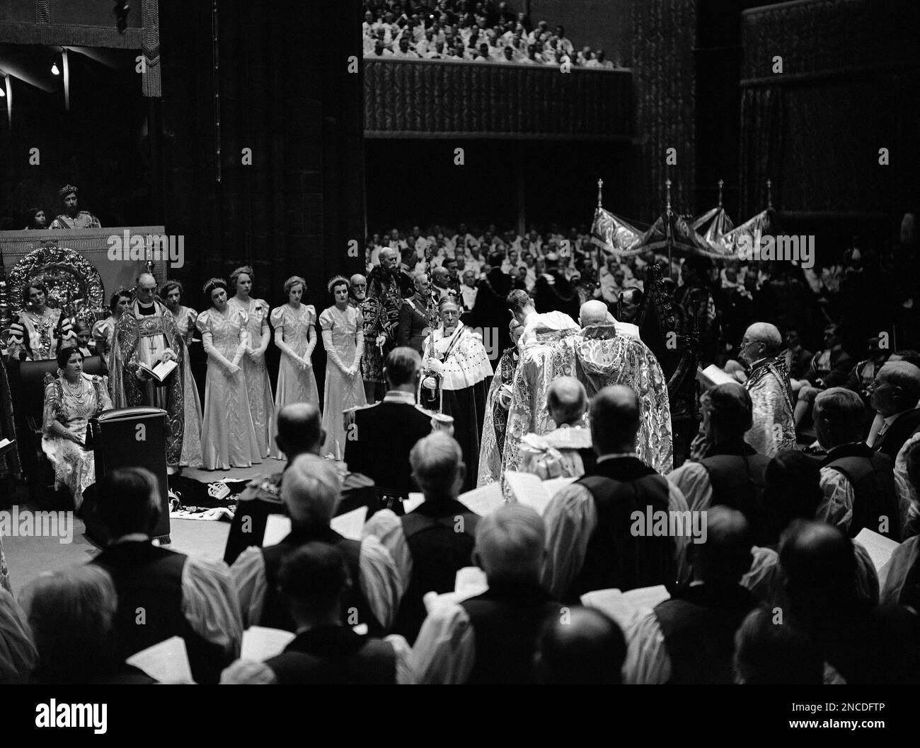 Britain's King George VI being invested with his Coronation robe during ...