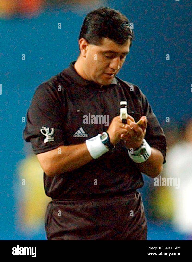 FILE - Ecuador's referee Byron Moreno, right, writes on his notebook at ...