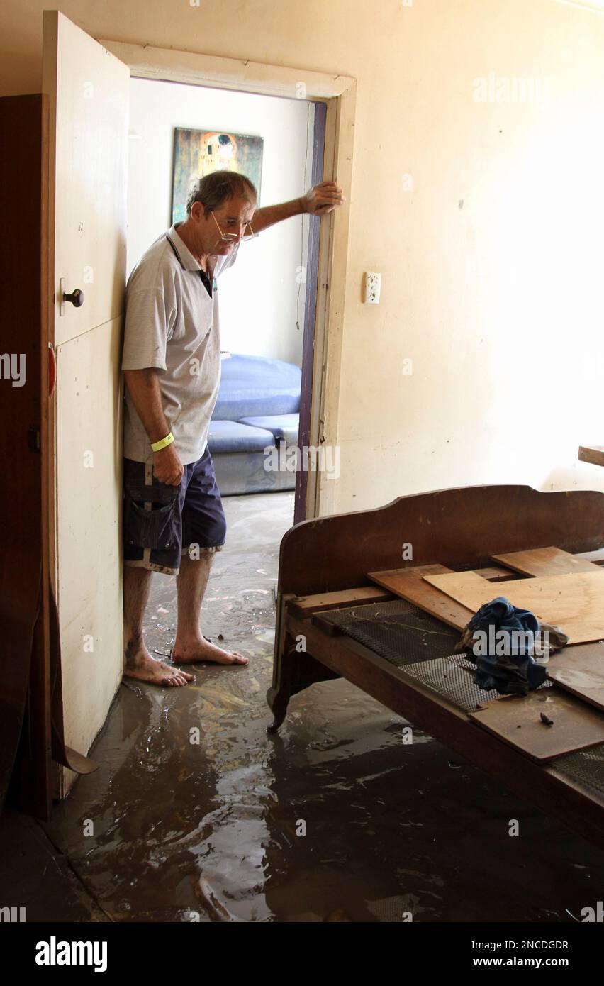 Steven Costin of New Farm observes the damage in his home in Brisbane ...