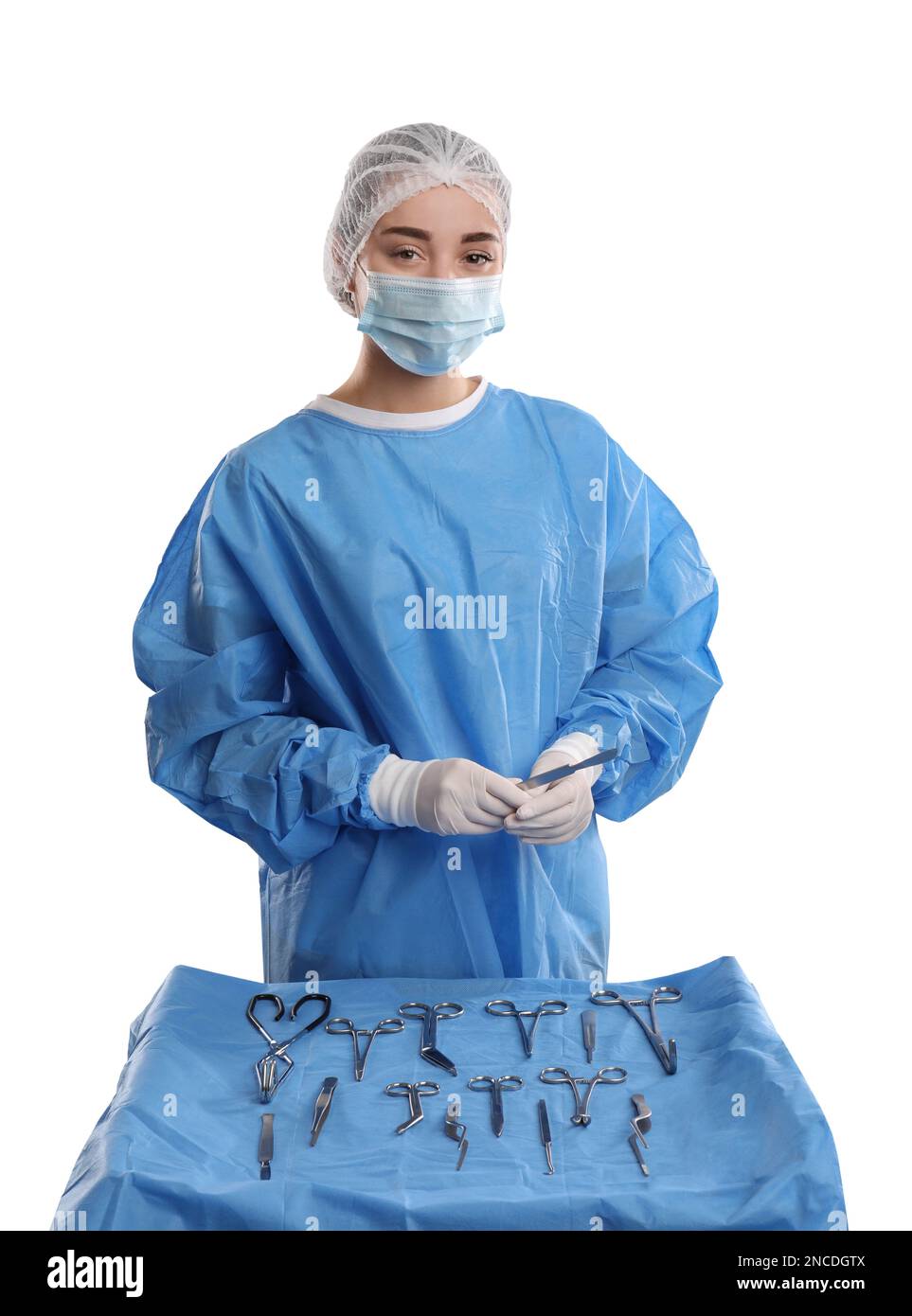 Doctor holding scalpel near table with different surgical instruments ...