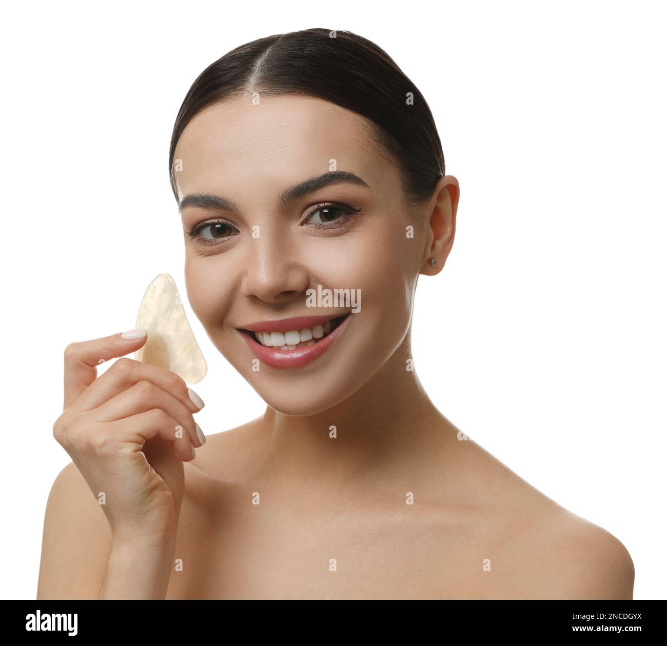 Beautiful young woman doing facial massage with gua sha tool on white background Stock Photo - Alamy