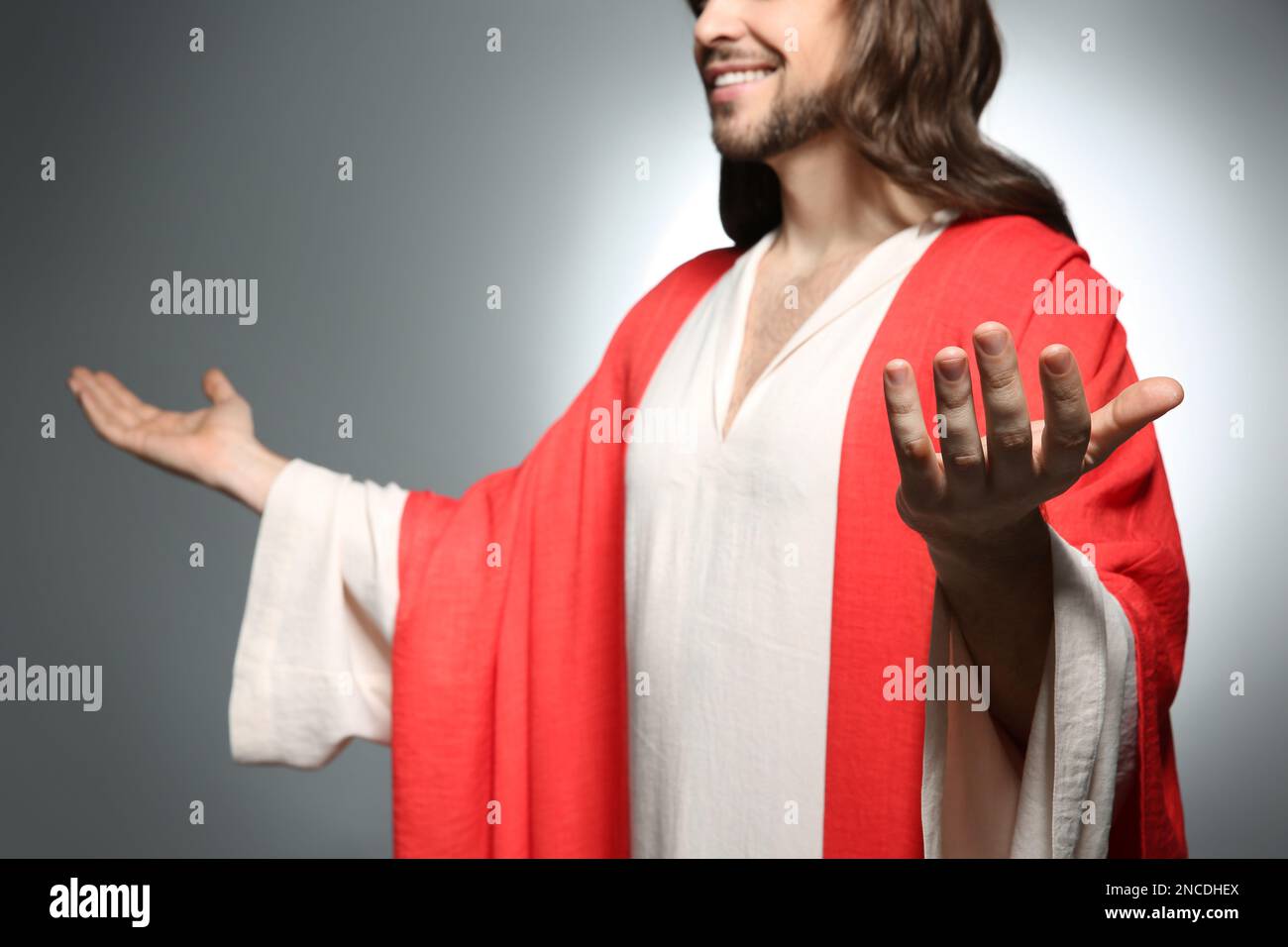 Jesus Christ reaching out his hands on grey background, closeup Stock ...