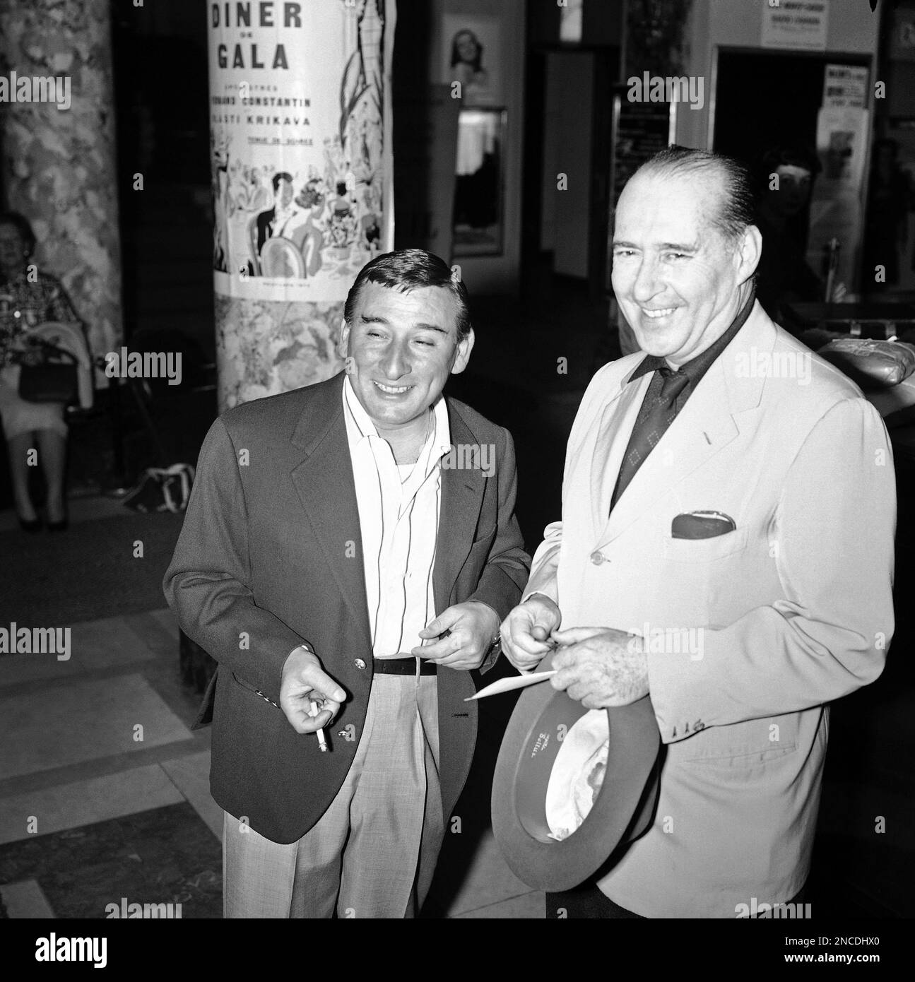 Smiling Italian film director Roberto Rossellini, right, chats in the ...